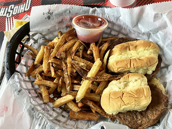 Mini burgers, maximum flavor. These sliders and fries prove that sometimes the best things come in small packages—and red plastic baskets.