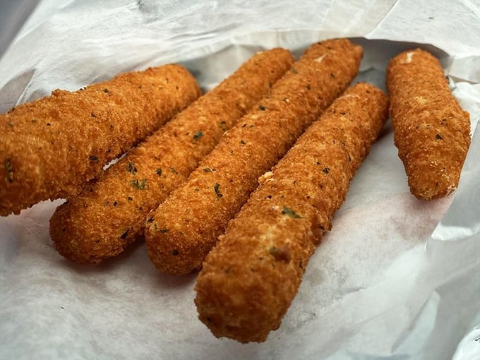 Mozzarella sticks that don't mess around—crispy, golden soldiers guarding their molten cheese treasure until that first perfect bite.