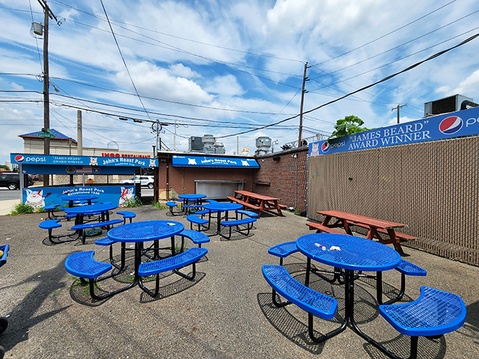 James Beard Award Winner banners don't lie—these blue outdoor tables have hosted more culinary joy than most white-tablecloth establishments ever will.