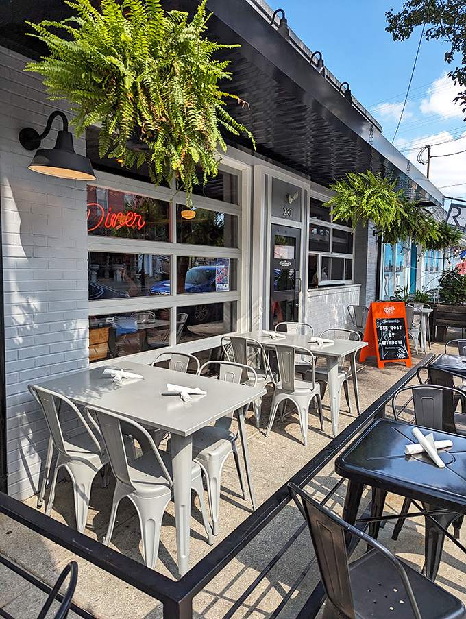 Hanging ferns and modern outdoor furniture transform a simple sidewalk into Milford's most coveted al fresco dining experience.