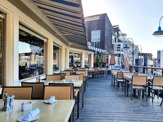 The outdoor deck—where sea breezes enhance every bite and Newport Harbor provides the ultimate dining backdrop.