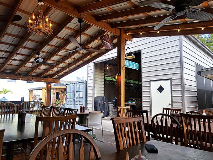 That chandelier hanging from a rustic wooden ceiling isn't an identity crisis—it's the perfect metaphor for barbecue that's both down-home and dignified.