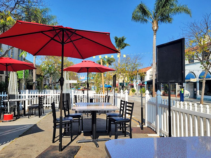 California sunshine and outdoor dining—name a more iconic duo. Those red umbrellas aren't just shade—they're exclamation points on a perfect day.