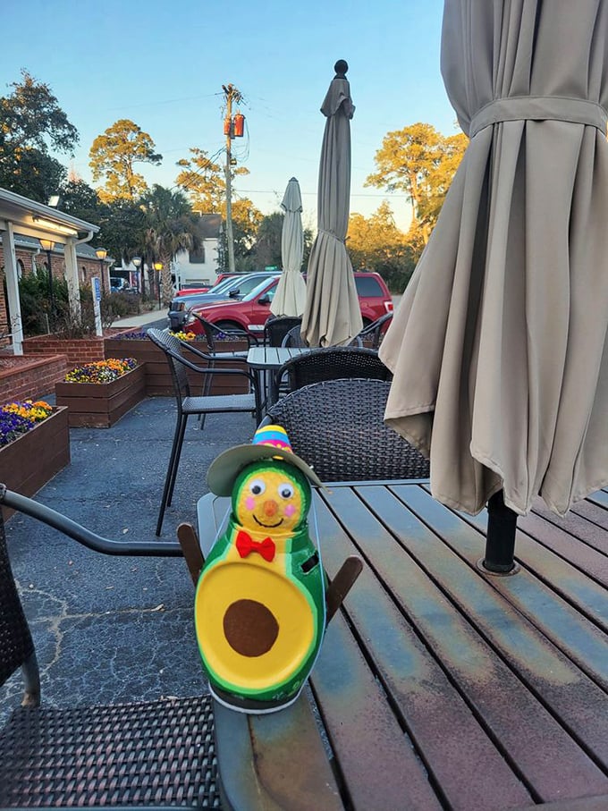 The outdoor seating area offers fresh air with your comfort food. That avocado mascot is living his best patio life.