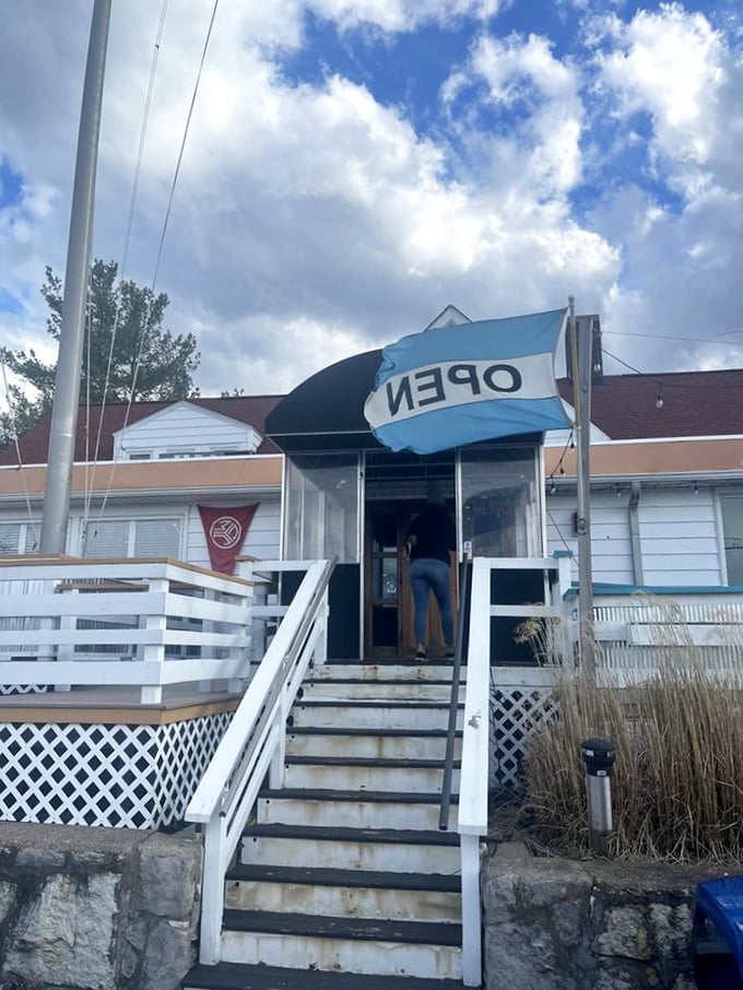 The entrance says "casual" but the flag says "open"—a combination that perfectly captures the inviting spirit of this lakeside gem.