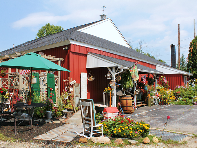 Sunshine illuminates this treasure-filled barn where garden ornaments, patio furniture, and seasonal blooms create an inviting outdoor gallery.