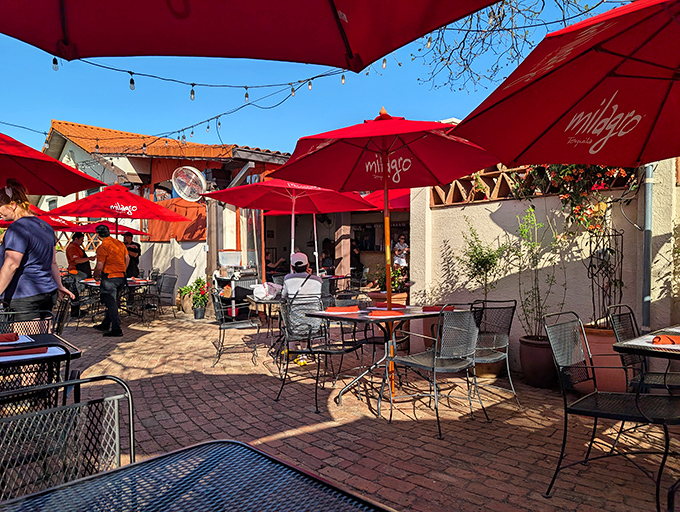 The outdoor dining area offers a slice of Austin heaven – string lights, red umbrellas, and the promise of enchiladas under the Texas sky.