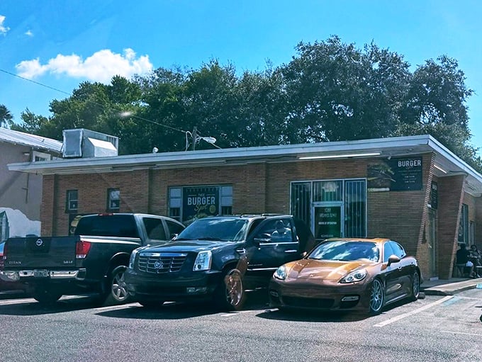 A parking lot filled with everything from work trucks to luxury cars—proof that good food is the ultimate social equalizer.