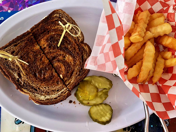 The humble patty melt—diner royalty on a plate. Those crinkle-cut fries are the perfect crunchy courtiers to this grilled sandwich monarch.