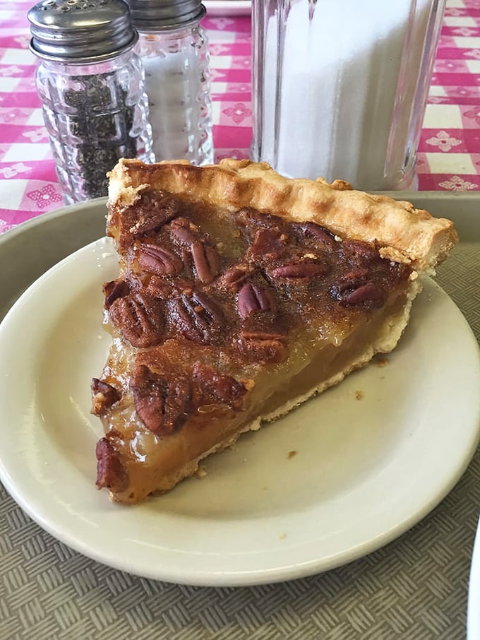 This isn't just pecan pie—it's Georgia's soul on a plate, with perfectly arranged pecans standing guard over caramel custard perfection.