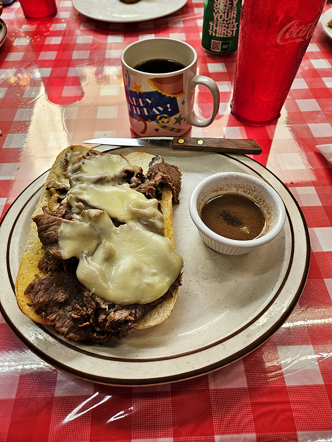 A hot beef sandwich that understands the importance of gravy geography. The melted cheese adds a creamy island in this savory landscape.