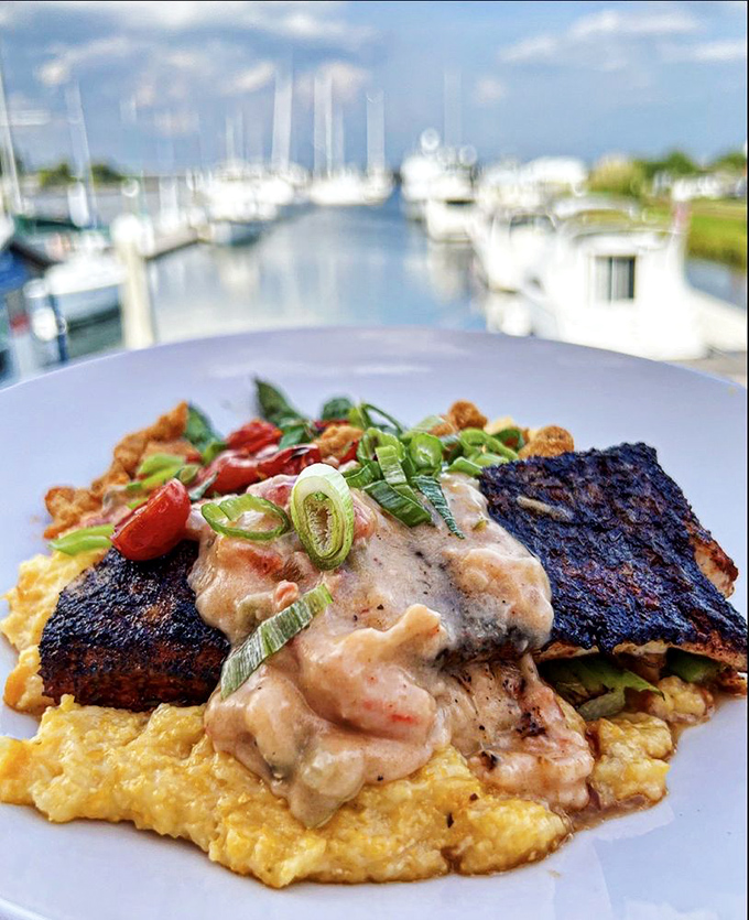 The Redfish Lafayette presents like edible art—blackened fish resting on golden grits with a sauce so good you'll consider drinking it directly.