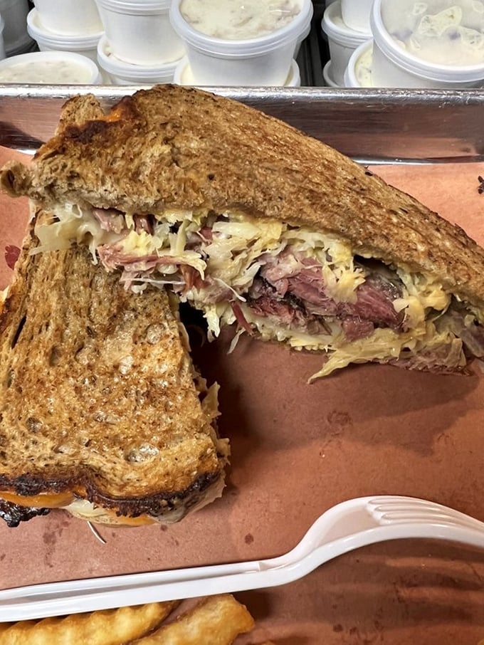 This isn't just a sandwich—it's a structural marvel. Layers of smoky meat and tangy slaw between toast that somehow maintains its integrity against all odds.