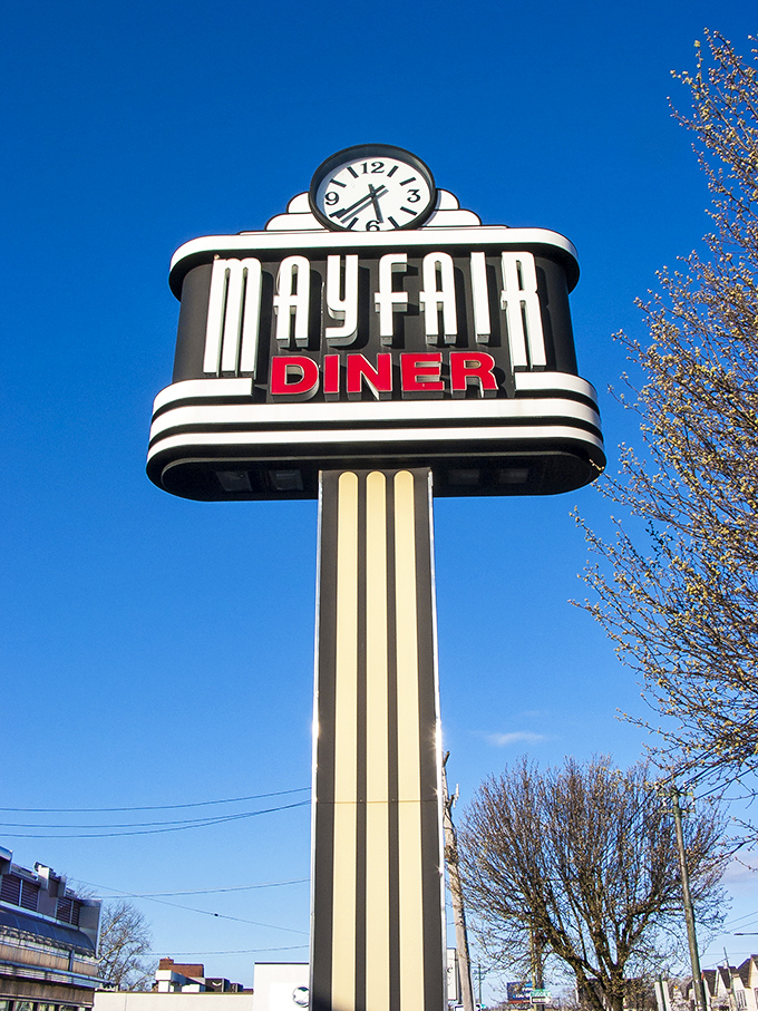 Against a perfect blue sky, the Mayfair's clock-topped sign stands as Philadelphia's answer to the North Star—guiding hungry travelers to breakfast bliss.