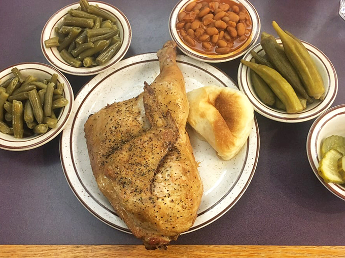A perfectly roasted chicken quarter surrounded by a garden of sides. This isn't just dinner – it's edible Texas heritage on a plate.