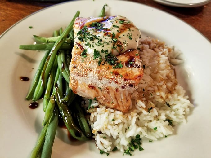 This salmon perched atop rice and green beans isn't just dinner—it's architecture, chemistry, and art conspiring to make your taste buds applaud.