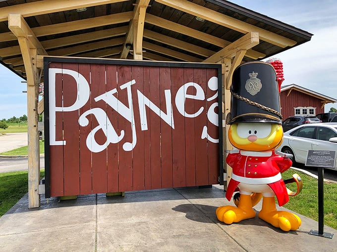 The playful duck mascot in royal guard attire stands sentinel beside the Payne's sign – a quirky British touch in the heart of Indiana.
