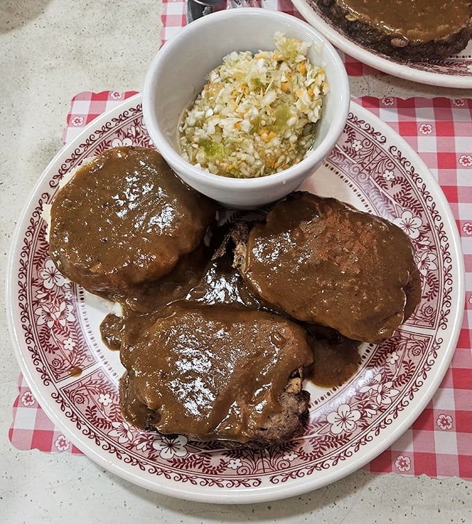 Salisbury steak swimming in rich brown gravy—comfort food that doesn't just feed your body but somehow manages to soothe your soul too. 