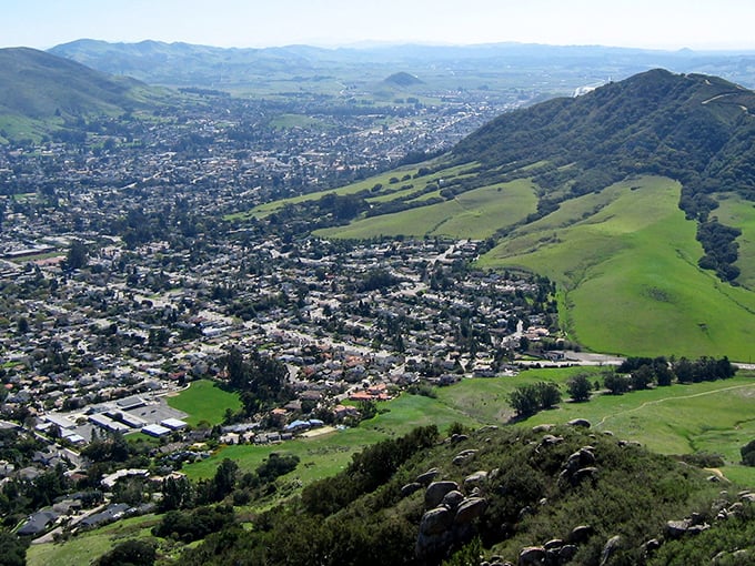 Rolling green hills embrace the valley, proving California's natural beauty never goes out of style.