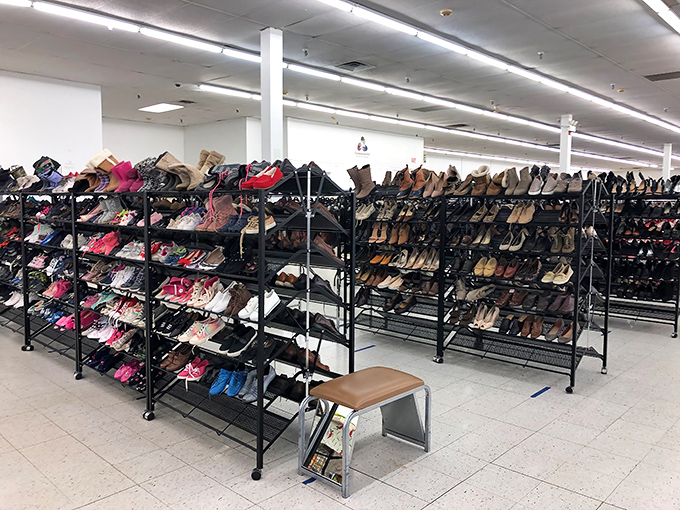 Shoe paradise stretches wall to wall, a footwear fantasy where designer heels and practical loafers sit side by side in democratic fashion.