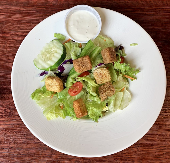 Even the side salad gets special attention – a fresh, crisp counterpoint to balance all that glorious barbecue indulgence.