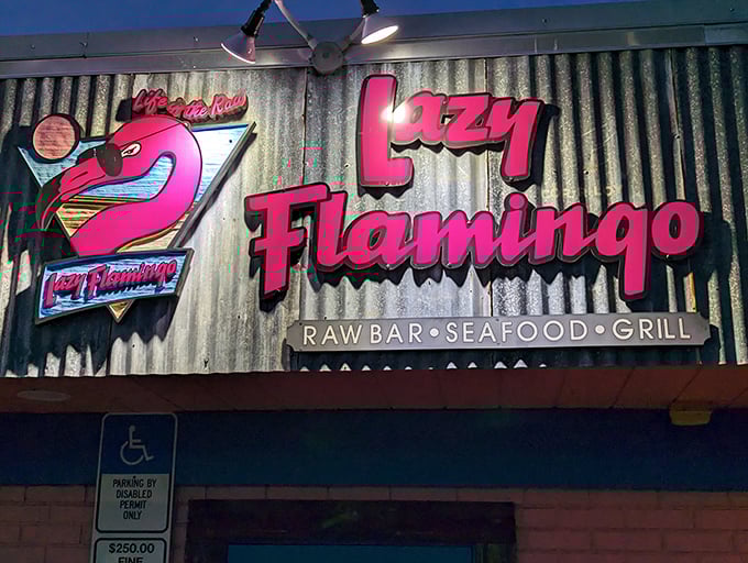 That neon pink sign isn't just a beacon for hungry travelers—it's a promise of the no-nonsense seafood paradise waiting inside.