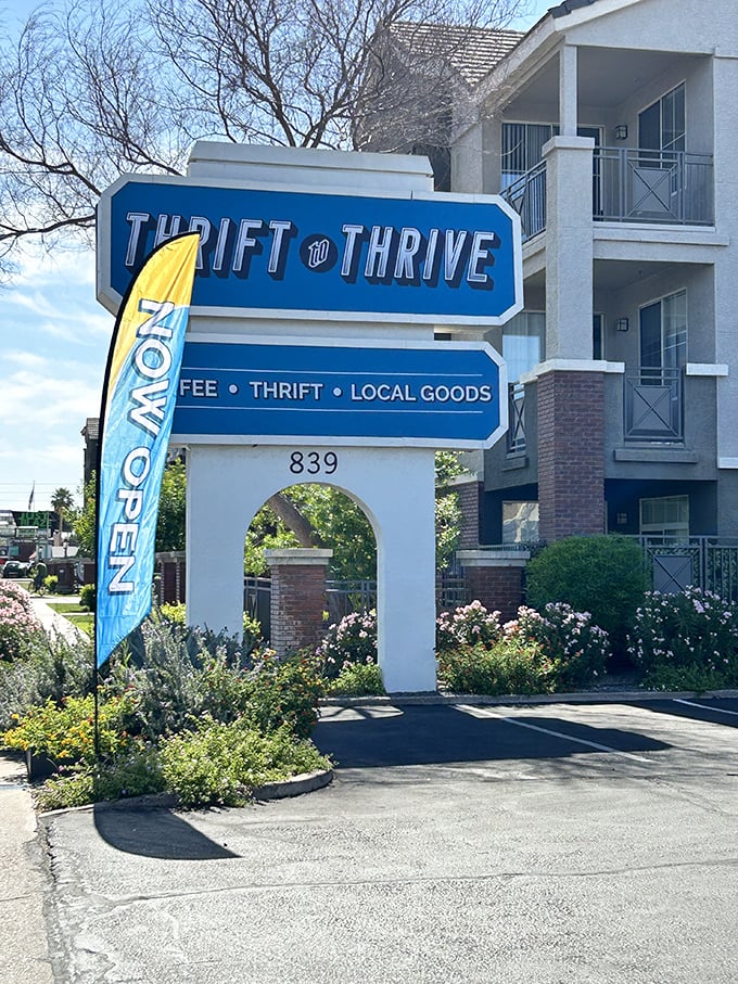 The official welcome sign stands proud, with its "NOW OPEN" flag dancing in the desert breeze – an invitation to sustainable shopping adventures.