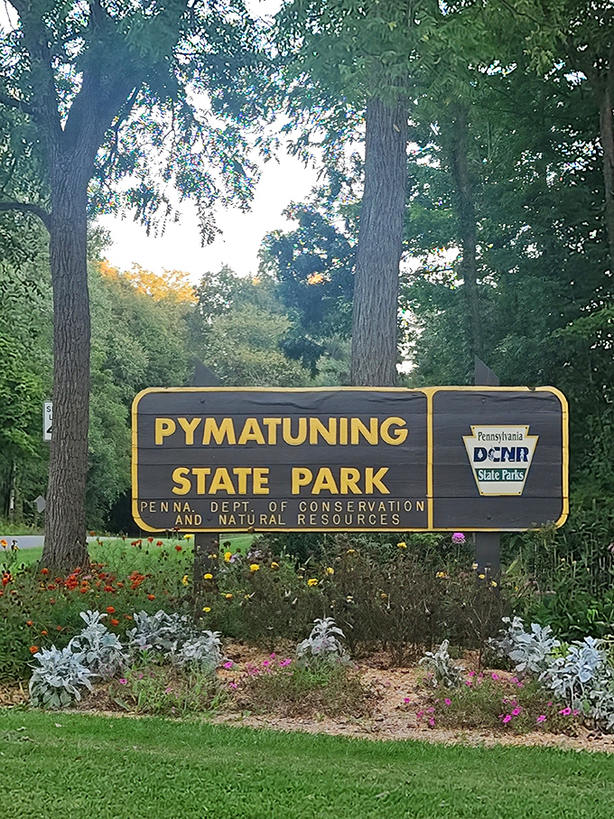 The entrance sign doesn't just mark a boundary—it's a promise of the natural wonders waiting beyond, complete with a floral welcome committee.