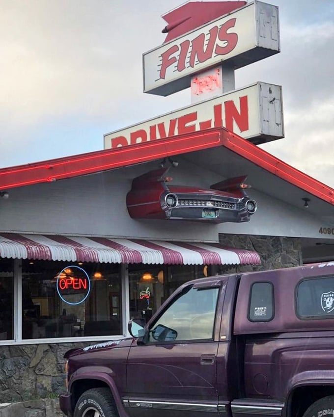 Not just a sign—it's a beacon of hope for the hungry. That vintage car built into the facade tells you this place takes its nostalgia seriously.