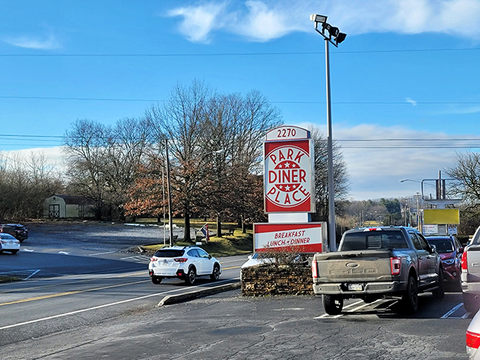 Roadside sign proudly announces breakfast, lunch, and dinner – your invitation to comfort food paradise.