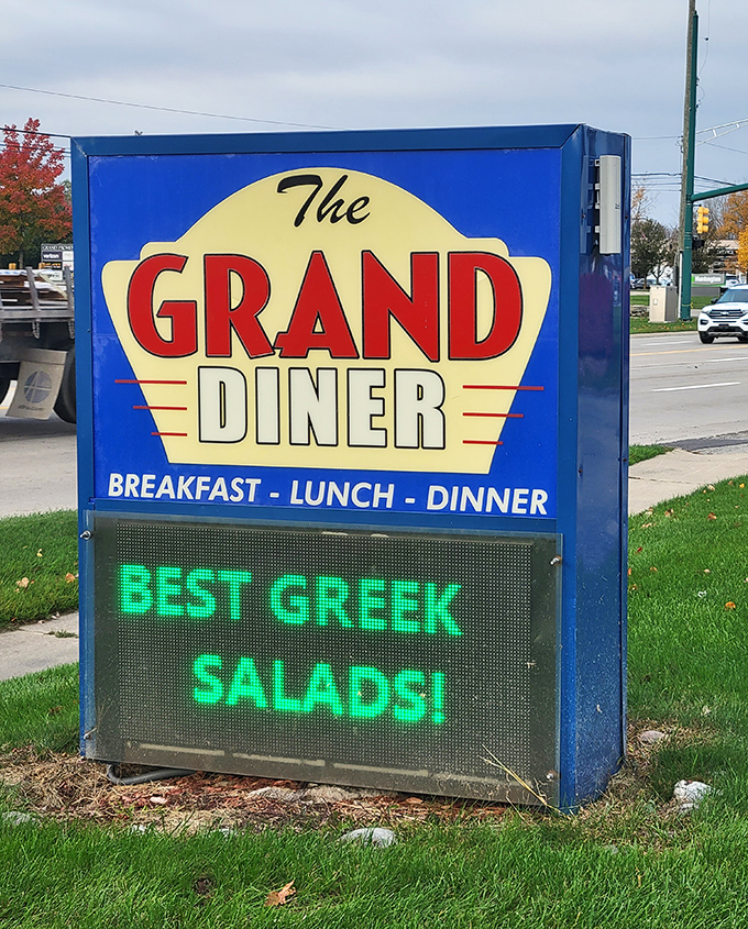 The roadside sign doesn't just advertise—it beckons. And those Greek salads must be something special to earn electronic billboard status.