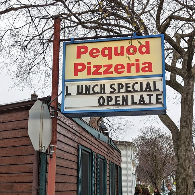 The iconic sign beckons pizza pilgrims like a lighthouse guiding hungry sailors home. "Open Late" – two beautiful words.