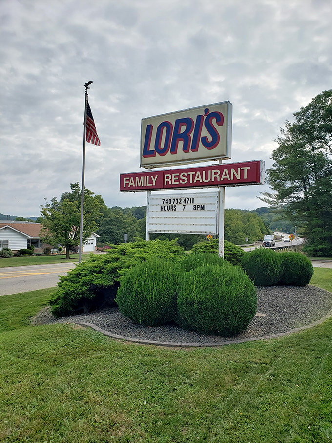 An American flag stands guard beside the iconic sign. Lori's isn't just a restaurant—it's a landmark that measures time in memorable meals.