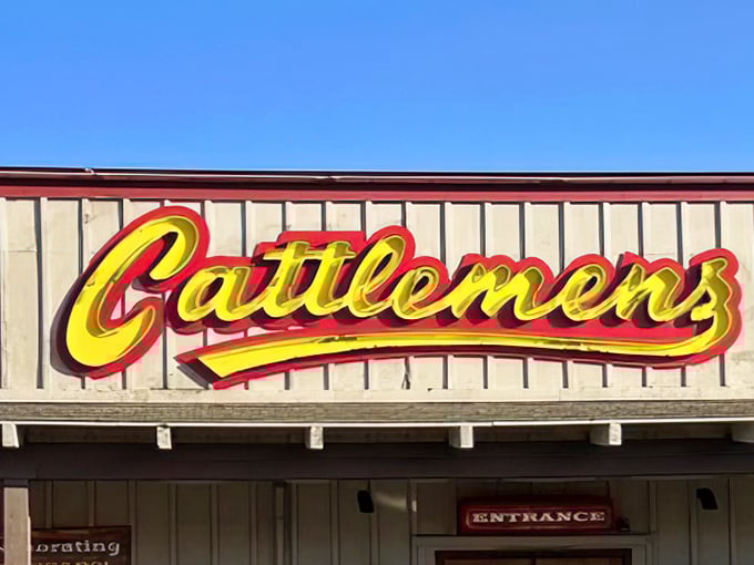 That signature yellow script against weathered wood—a sign that's guided generations of hungry Californians to steak salvation.