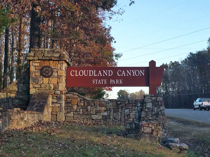 The entrance sign, framed by stone and autumn foliage, serves as Georgia's version of "You Are Now Entering Paradise"—no passport required.