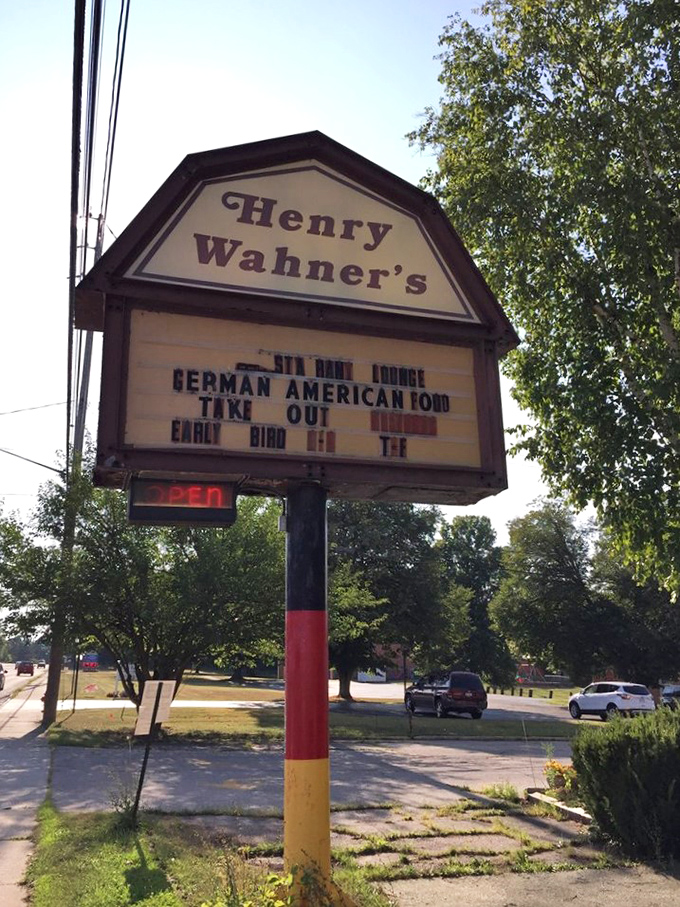 The roadside sign stands like a beacon of hope for hungry travelers—German-American food that promises to solve all of life's problems, at least temporarily.