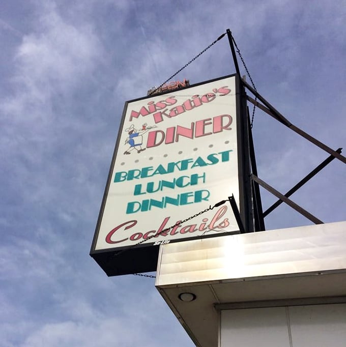 The retro signage promises the holy trinity of diner perfection: breakfast, lunch, dinner—with cocktails as the bonus blessing.