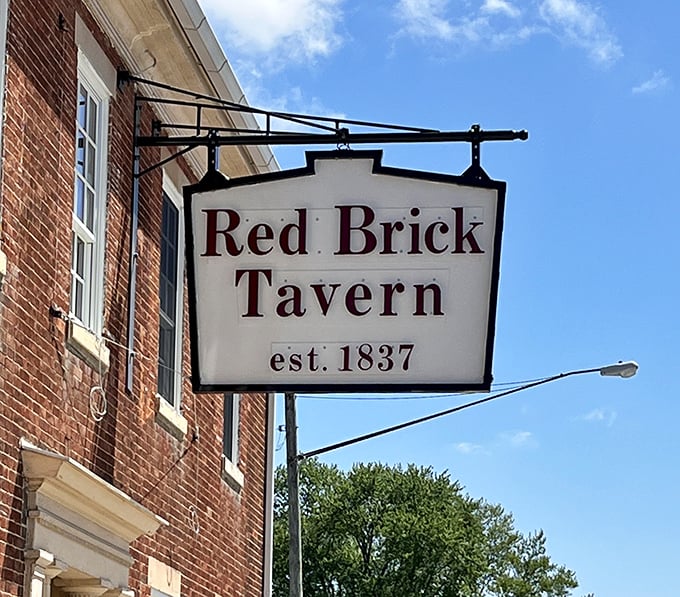 
The simple hanging sign announces the tavern's presence without fanfare—just like the establishment itself, letting its centuries-old reputation do the talking. 