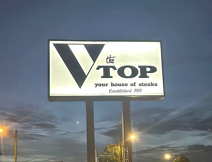 The vintage sign glows against the twilight sky, a beacon for hungry travelers. "Your house of steaks" isn't just a tagline—it's a promise.