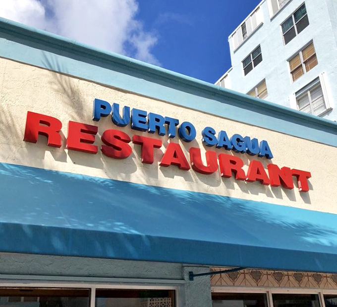 The restaurant's name blazes in red and blue against Miami's perpetual sunshine—a beacon of authenticity in a sea of trendy pretenders.