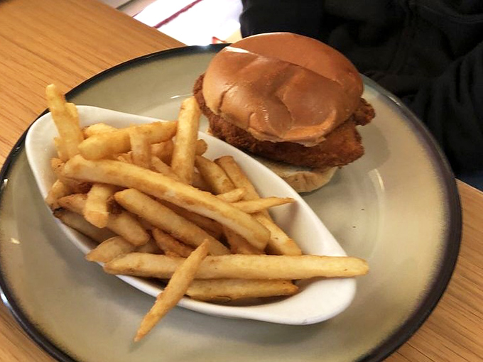 A chicken sandwich that doesn't need a social media manager – just honest fried goodness on a bun with perfectly crisp fries.