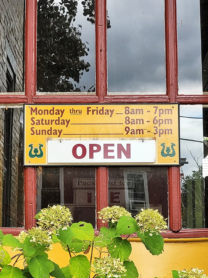 These aren't just store hours—they're an invitation. A yellow sign promising that rural hospitality awaits, whether you arrive at 8am or just before closing.