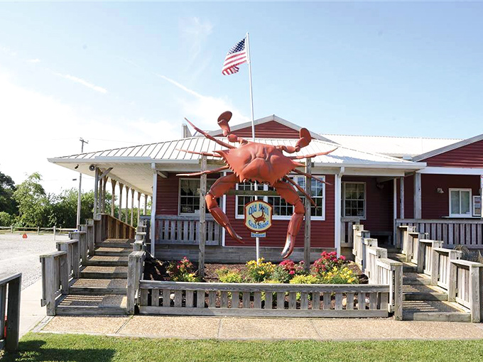 That giant red crab guarding the entrance isn't just decoration—it's the unofficial mayor of Delmar, welcoming hungry pilgrims to seafood paradise.