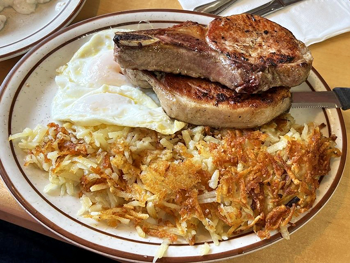 Pork chops, eggs, and hash browns—the breakfast of champions who plan to skip lunch and possibly dinner. Morning ambition on a plate.