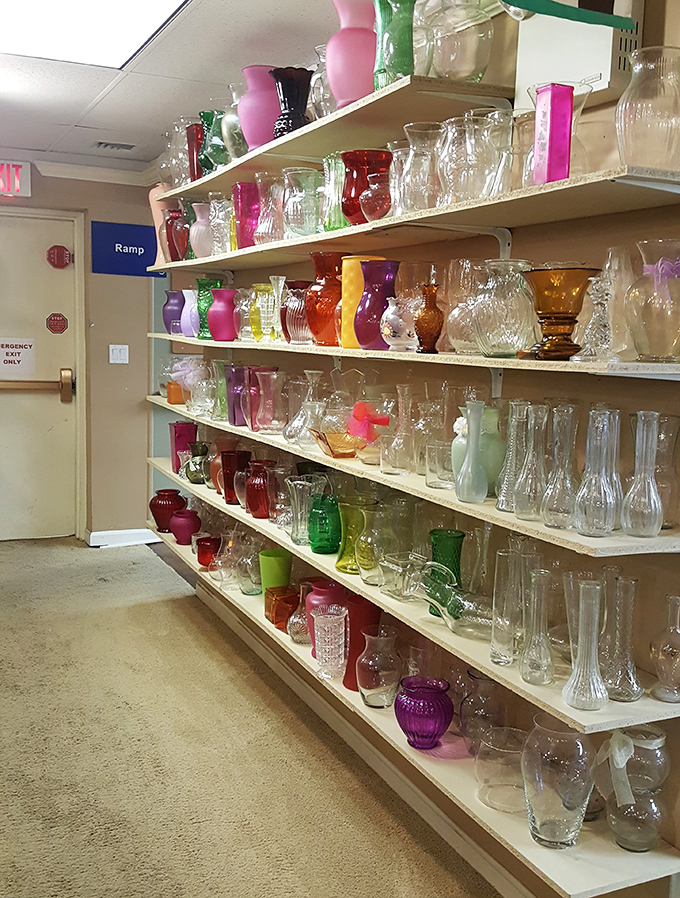 A rainbow of glass vases catches the light like an indoor sunset – from mid-century modern to Victorian, each with stories to tell.