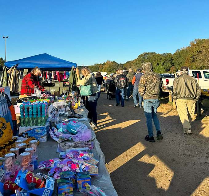 The outdoor extension of bargain paradise! Early morning shoppers scan tables with the focus of archaeologists on the verge of a major discovery.