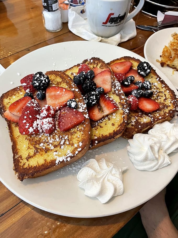 French toast that doubles as a berry delivery system—proving that bread's highest calling is to be soaked, griddled, and fruit-topped.