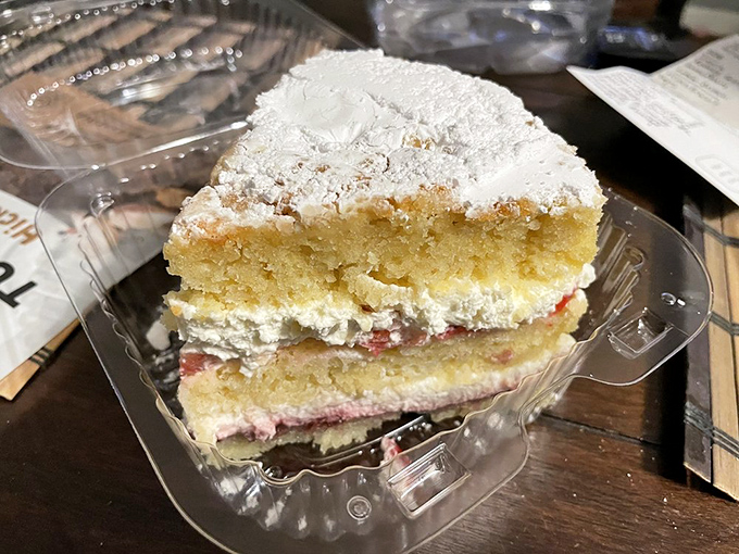This Victoria Sponge looks like it just stepped out of Buckingham Palace – royally dusted with powdered sugar and hiding jammy secrets within.