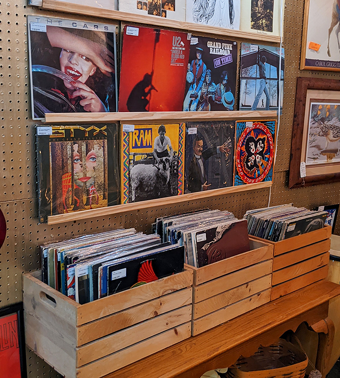Album art as wall art—vinyl records displaying their colorful sleeves like badges of musical honor. The soundtrack of generations stored in wooden crates.