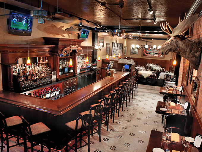 The bar at Salmon Dave's isn't just a place to drink—it's a wood-paneled sanctuary where maritime charm meets Midwest hospitality, complete with moose to keep watch.